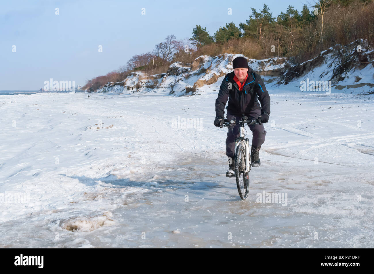 Man on bike in snow hi-res stock photography and images - Alamy