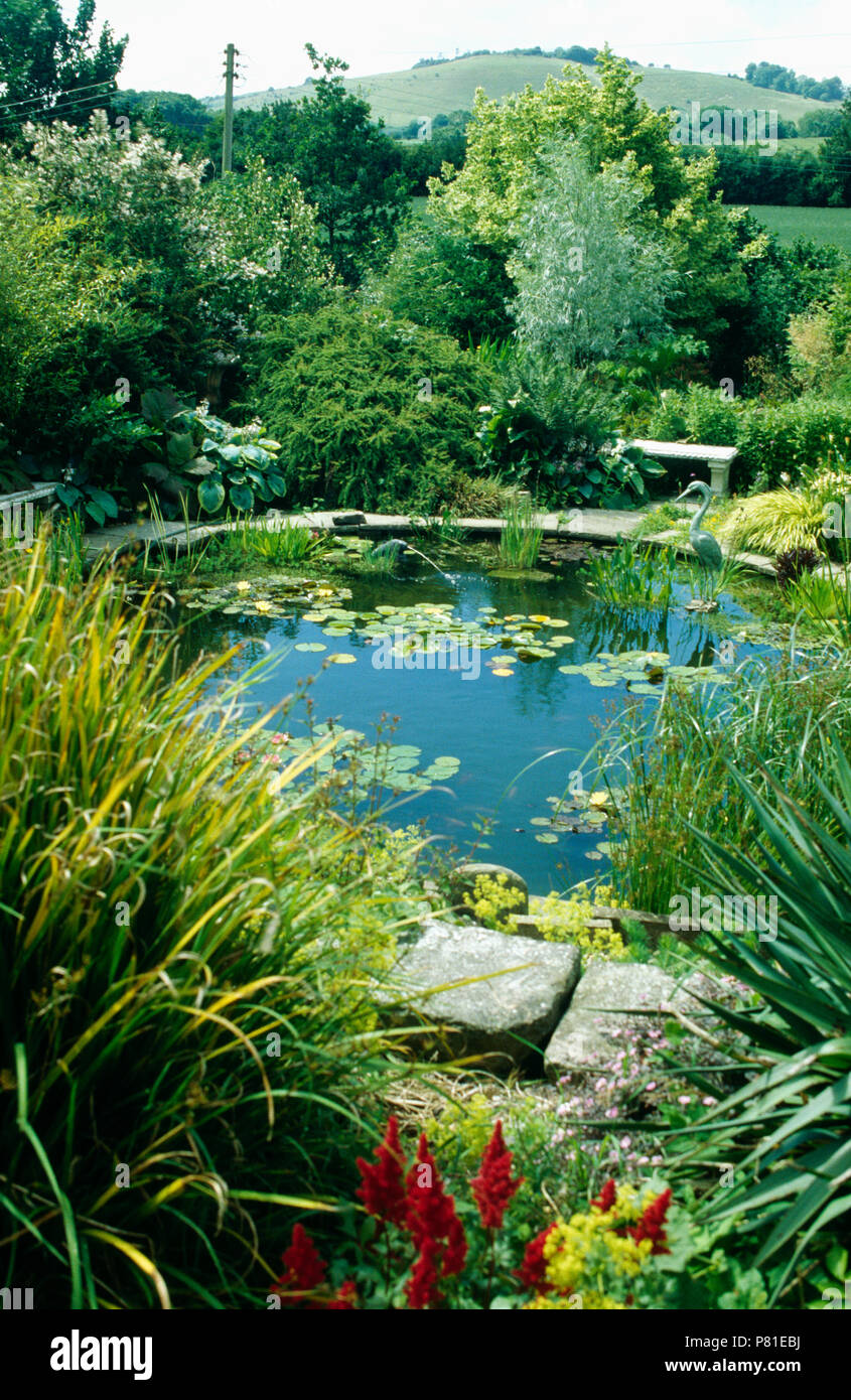 Large circular pond in country garden Stock Photo - Alamy