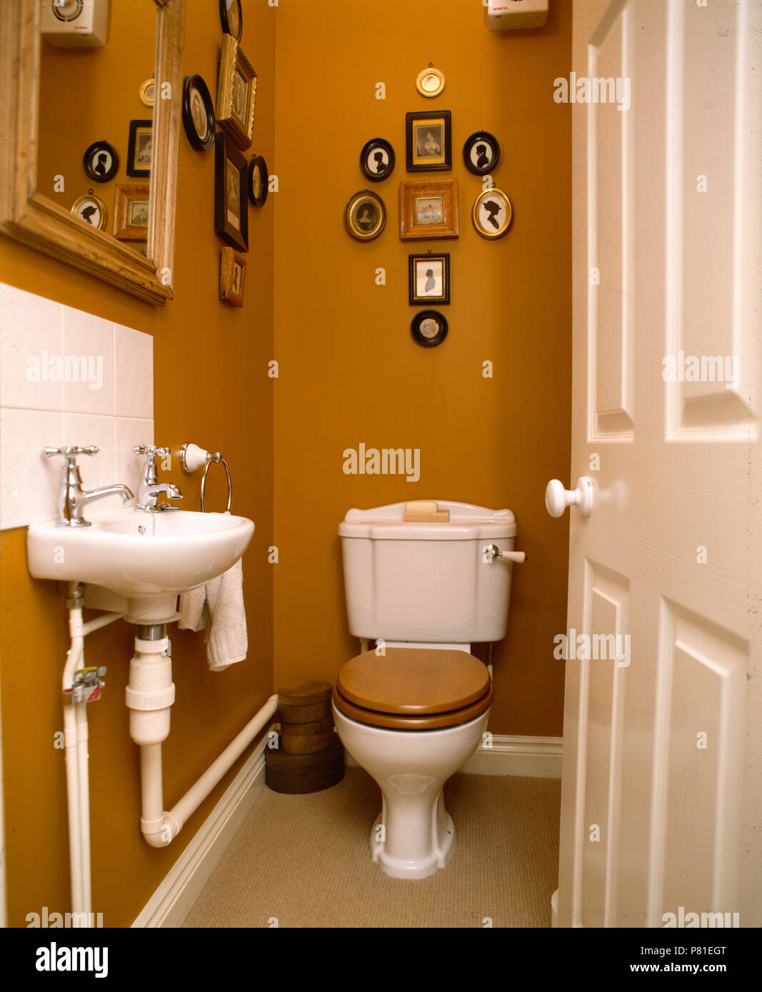 terracotta paint in cloakroom with white sanitary wear Stock Photo - Alamy