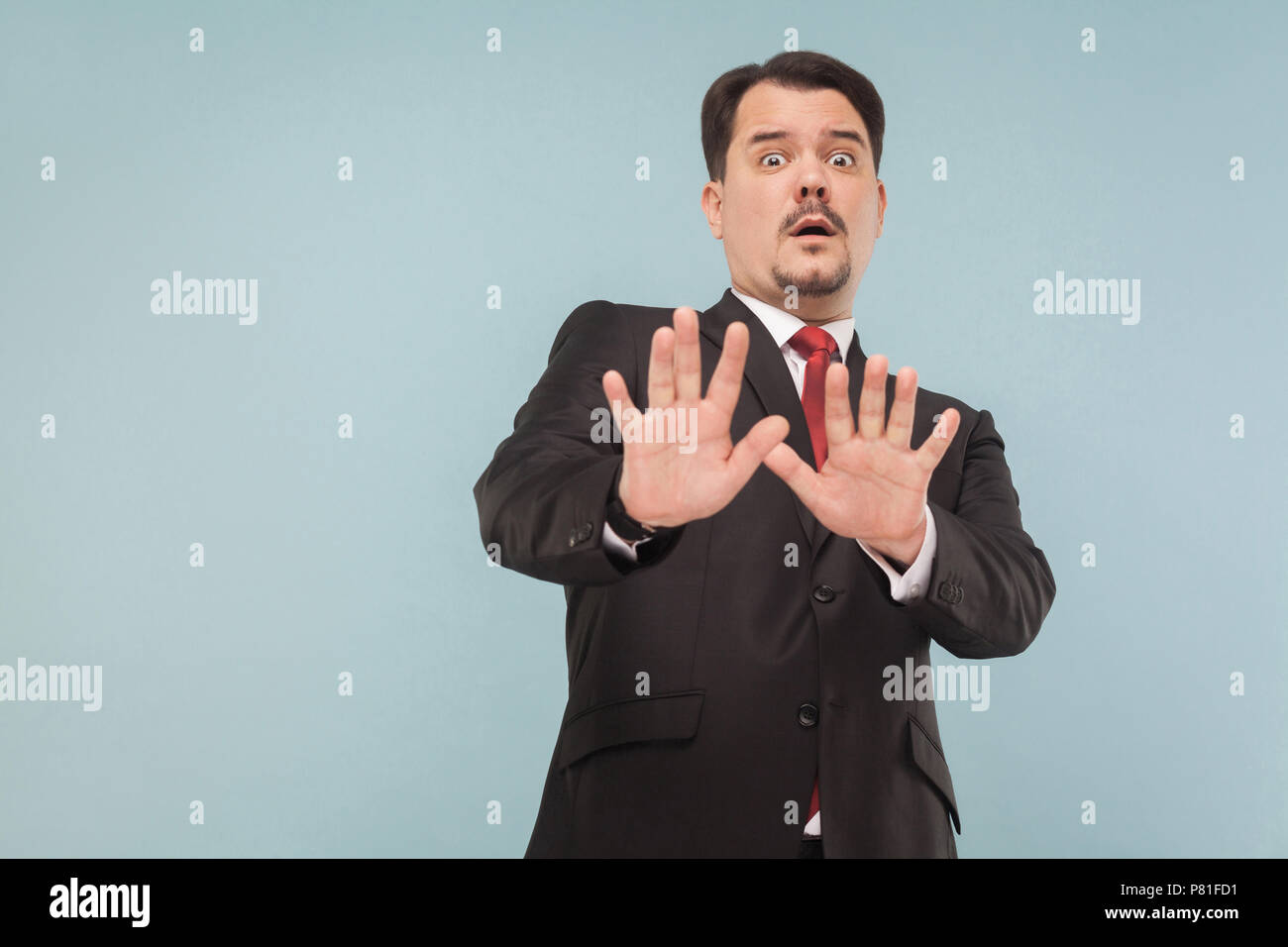 Businessman panic. Nervous man in suit scared and looking at camera ...