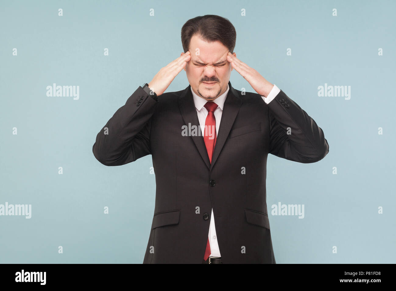 Problems at work, symptoms of disease. Man holding head and have ...