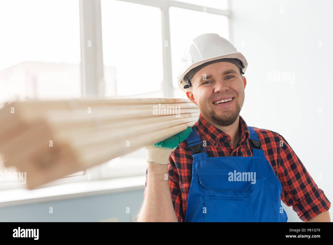 Portrait of handsome male builder laughing infront of window Stock ...
