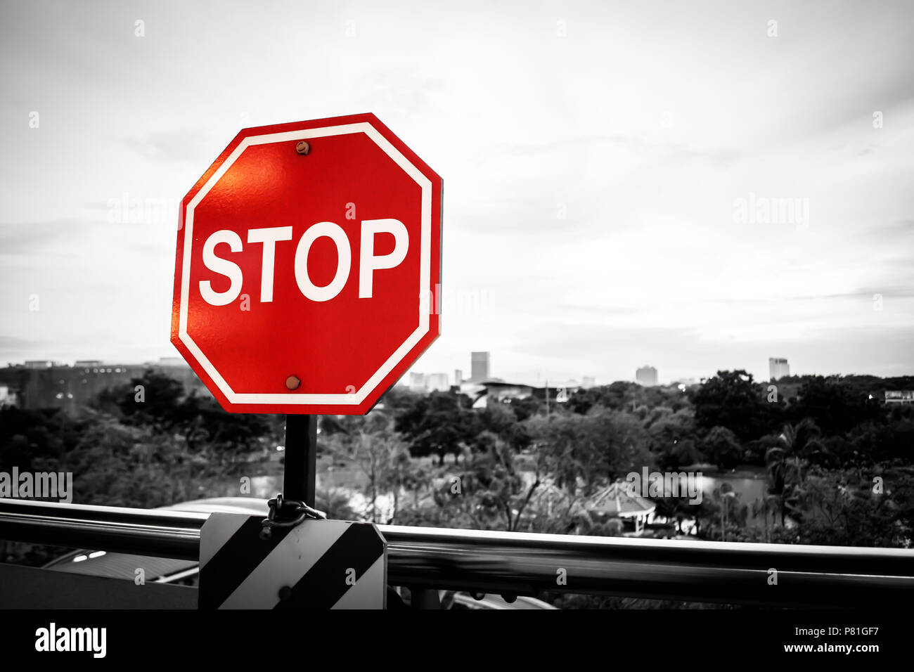 Stop sign in a black and white image with City Landscape Stock Photo ...