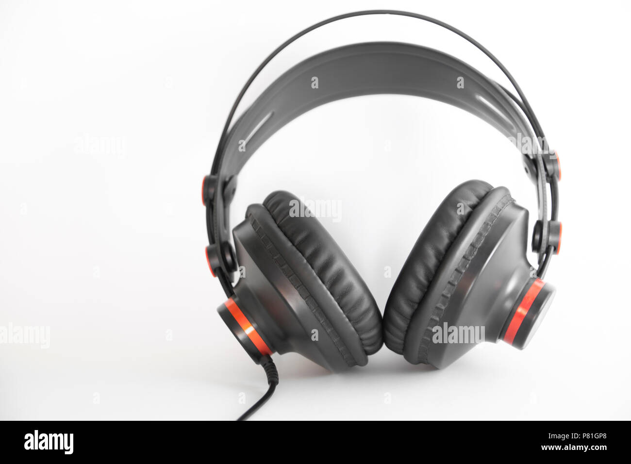 modern studio headphones, black with small red list on white background ...