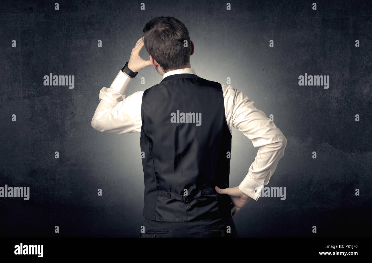 Young businessman standing and thinking alone Stock Photo - Alamy