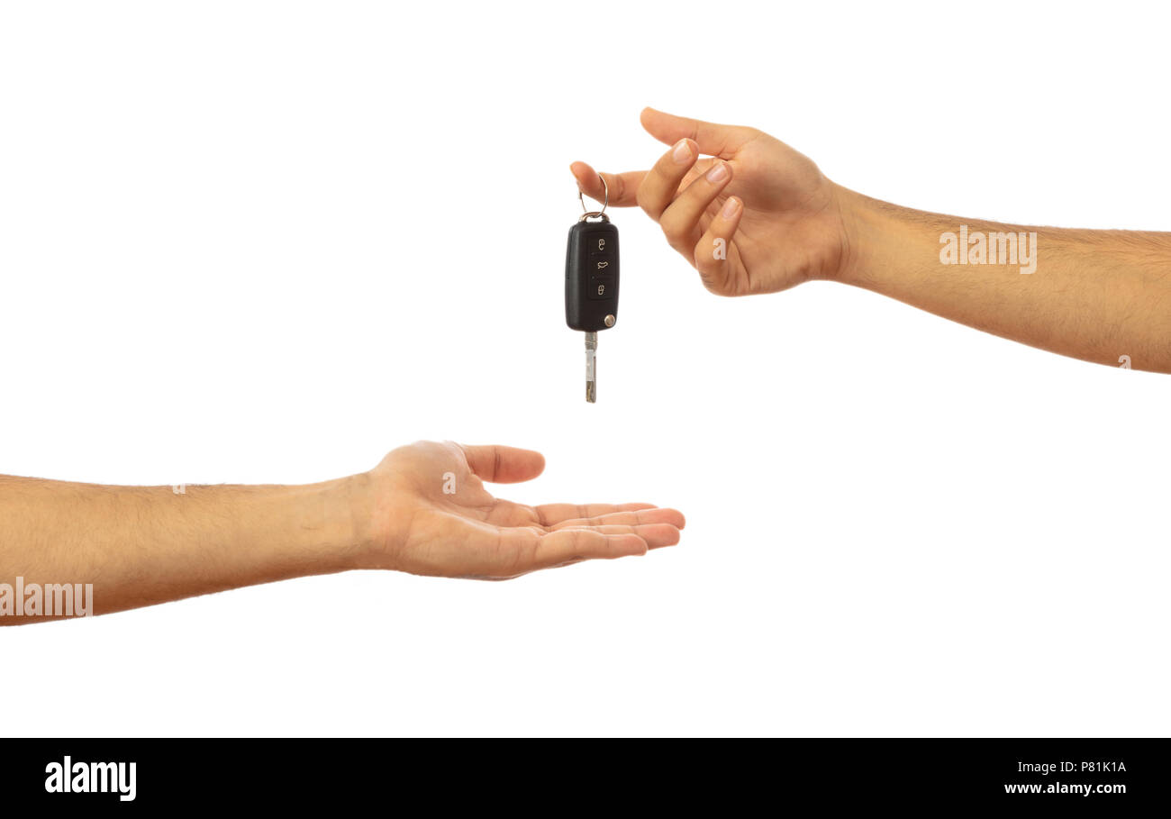 Handing over the car key. Male hands isolated on white background ...