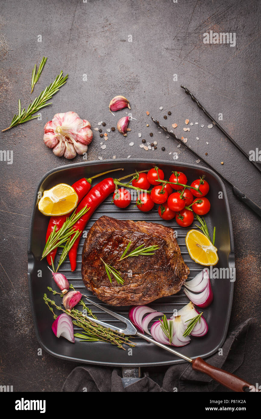 Baked grilled beef slice in a scoop with spices and vegetables, top ...