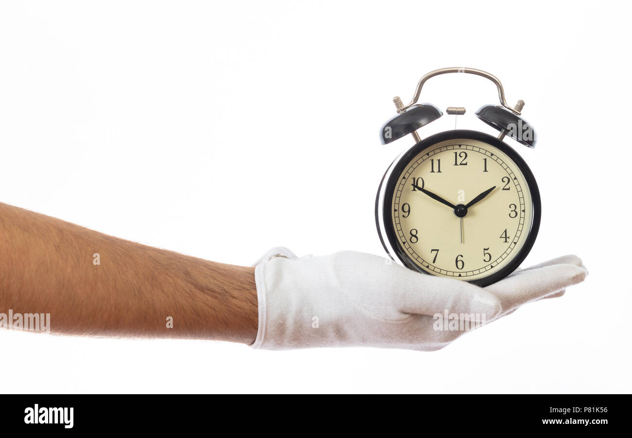 Alarm clock on a gloved male hand isolated on white background ...