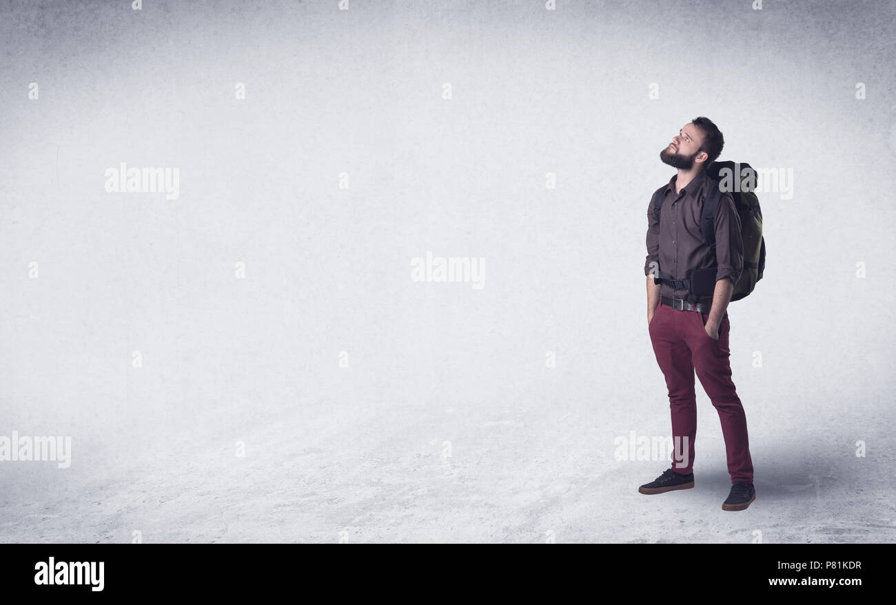 Standing handsome young man with a backpack Stock Photo - Alamy