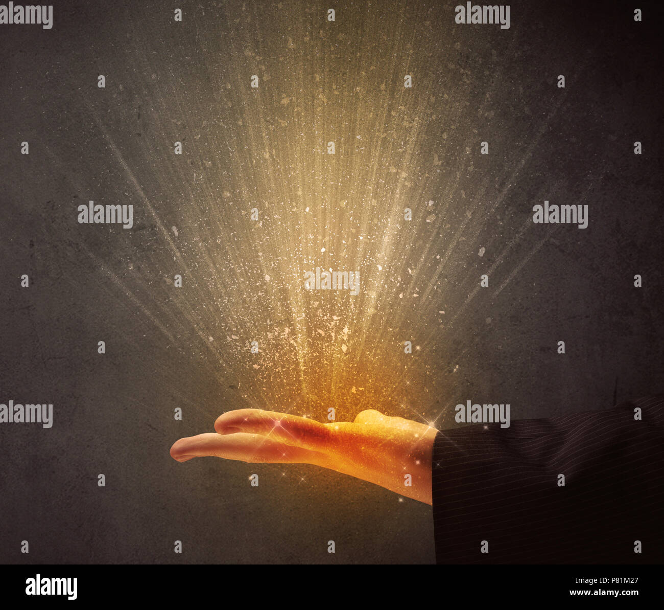 Yellow ray of light coming from a young hand Stock Photo - Alamy