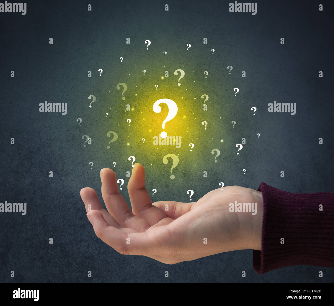 Yellow question marks hovering over young hand Stock Photo - Alamy