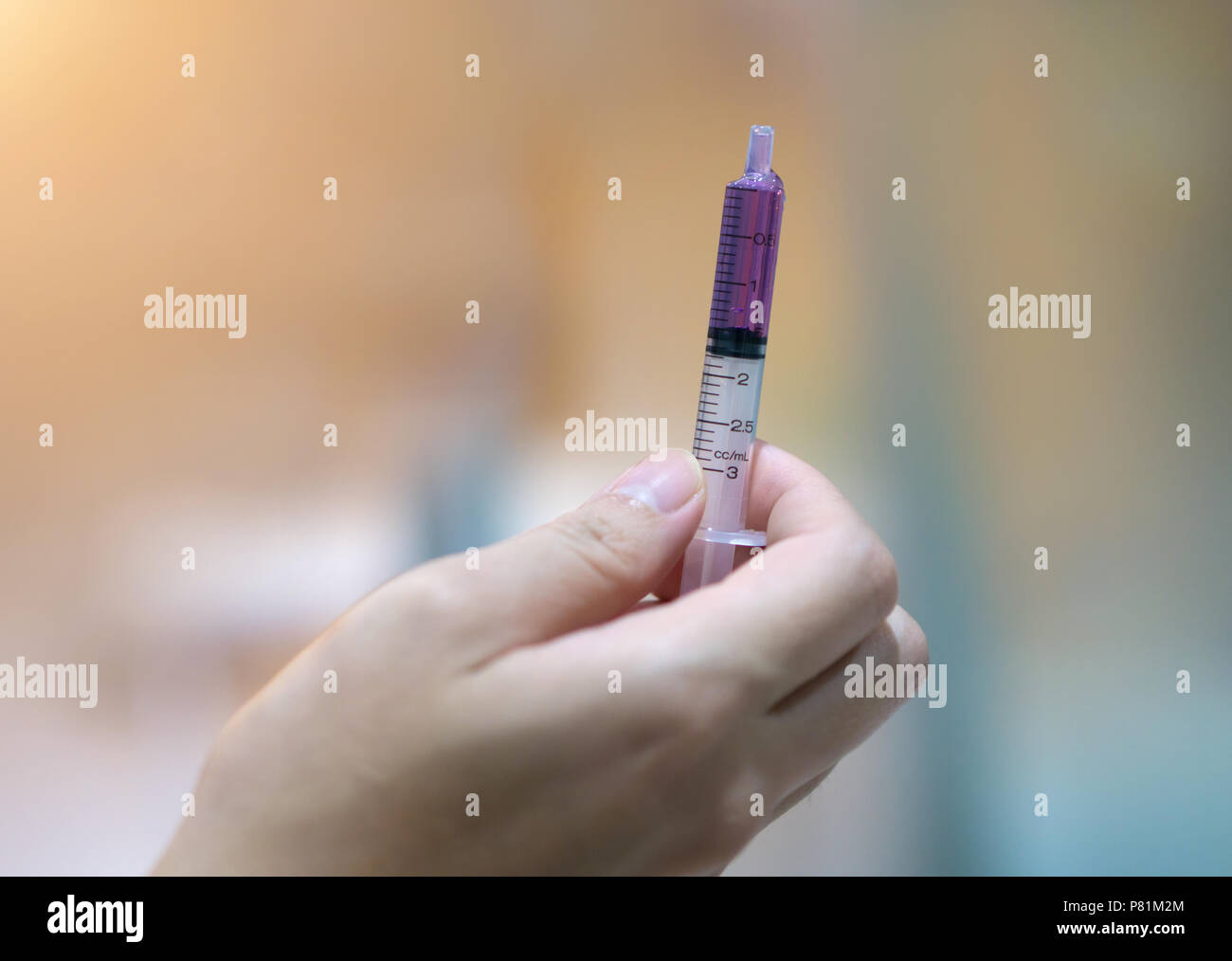 Asian women holding a syringe for an infant medication Stock Photo - Alamy