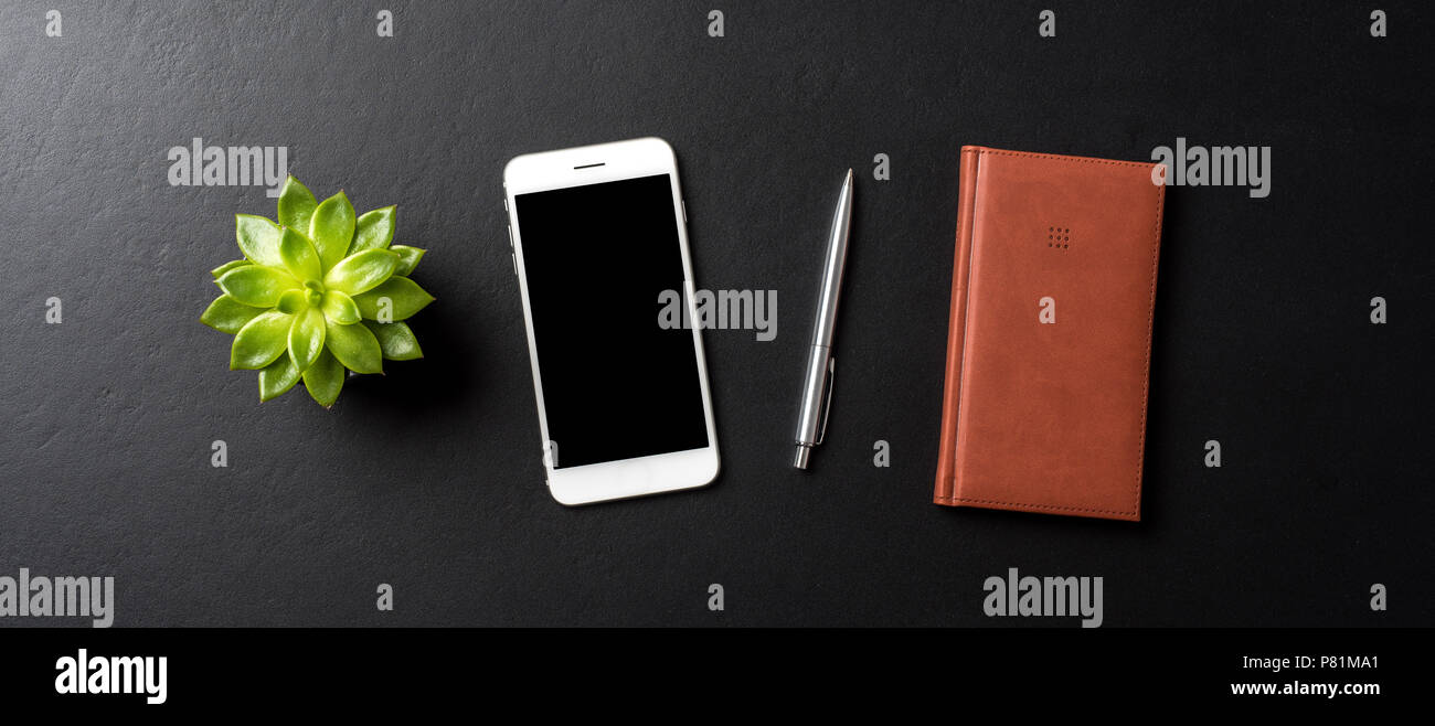 Office desktop with pen, smart phone and notebook Stock Photo - Alamy