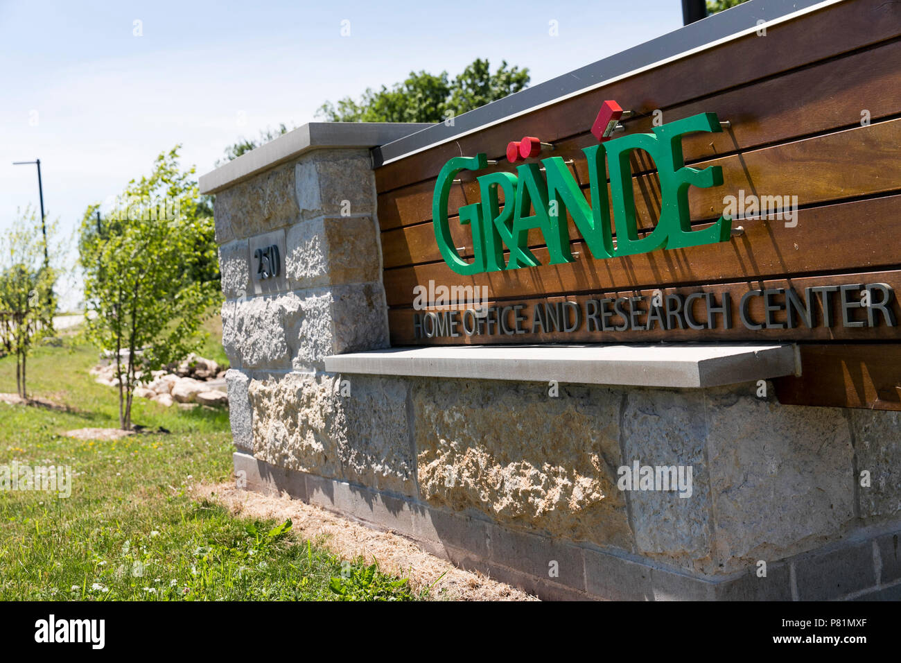 A logo sign outside of the headquarters of the Grande Cheese Company in ...