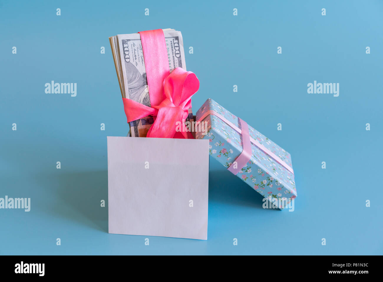 U.S. dollars banknotes laying in bow decorated gift box. Opened gift ...