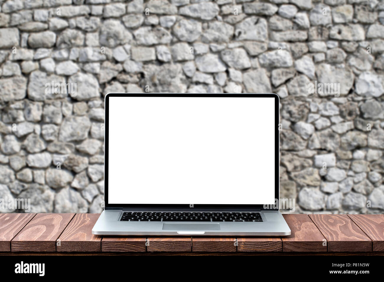 Modern laptop with empty white screen on wooden table against blurred ...