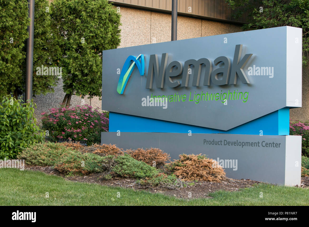 A logo sign outside of a facility occupied by Nemak in Sheboygan ...