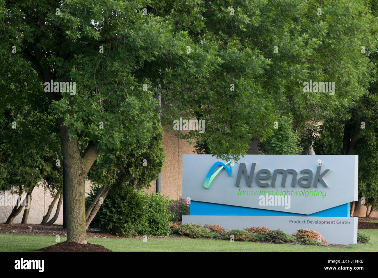 A logo sign outside of a facility occupied by Nemak in Sheboygan ...