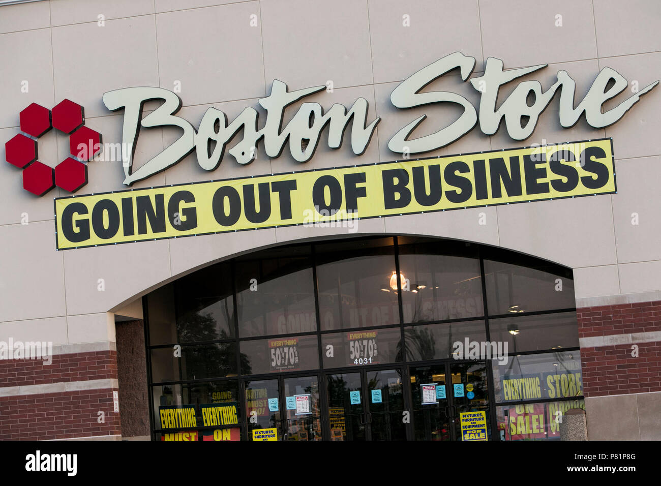 A logo sign and 'Going Out Of Business' banner outside of a Boston ...