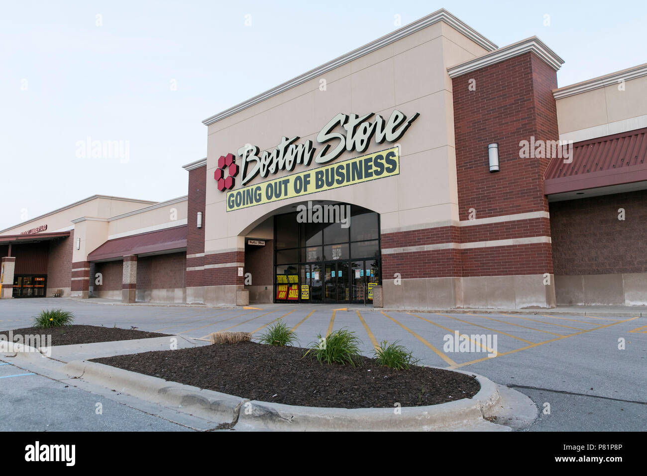 A logo sign and 'Going Out Of Business' banner outside of a Boston ...