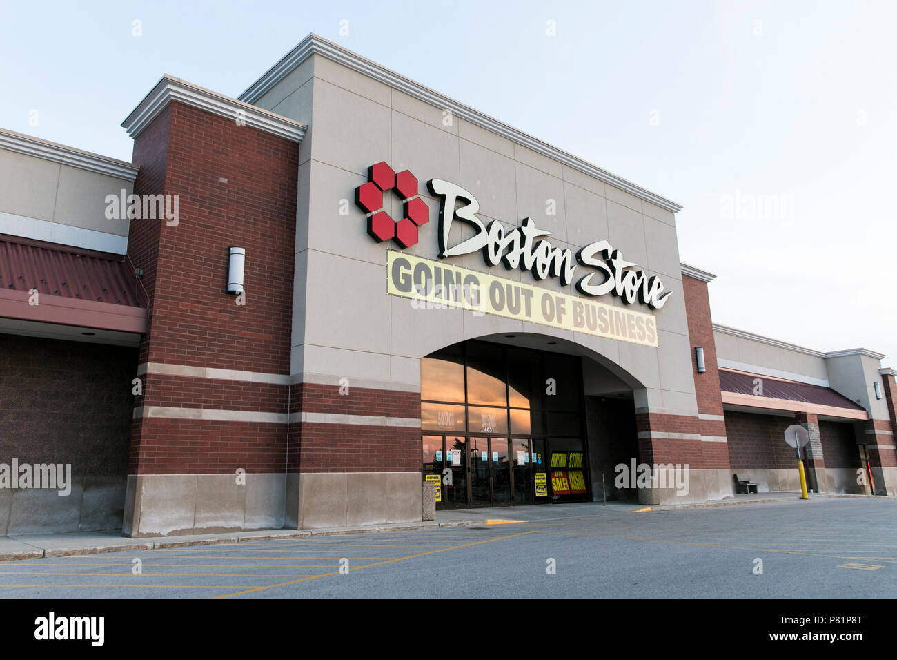 A logo sign and 'Going Out Of Business' banner outside of a Boston ...