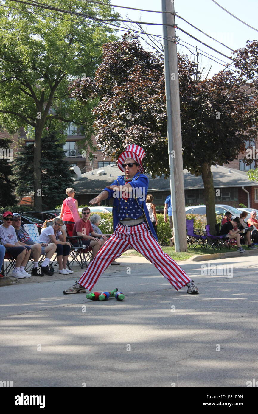 Juggler dressed up in a red white and blue Uncle Sam outfit and ...