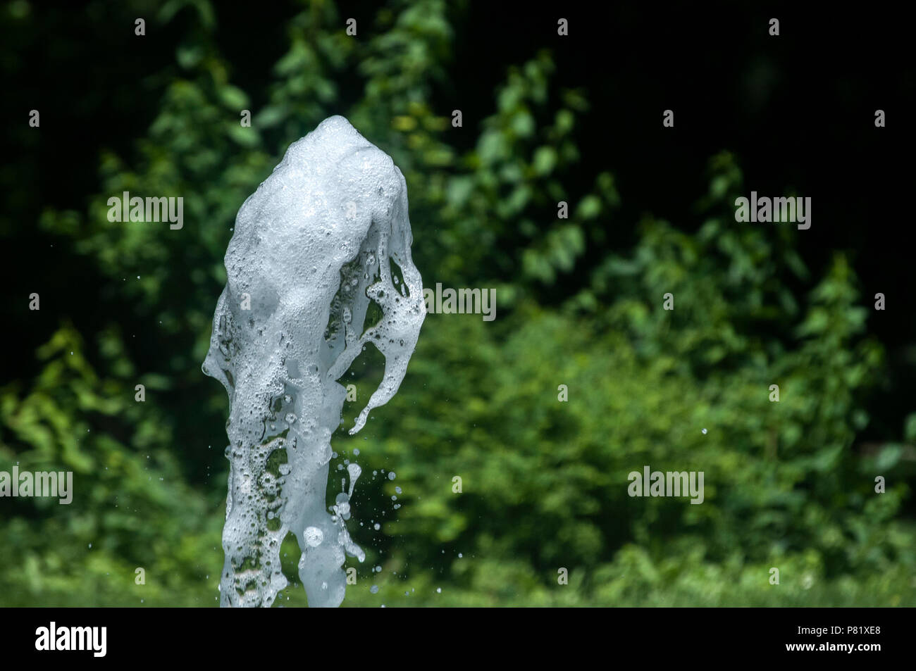 A close snapshot of gushing water with bizarre forms from a fountain in ...