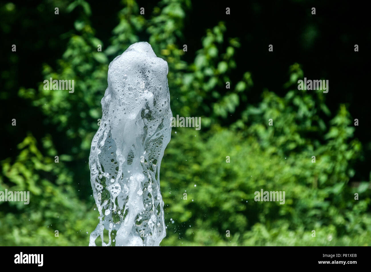 A close snapshot of gushing water with bizarre forms from a fountain in ...
