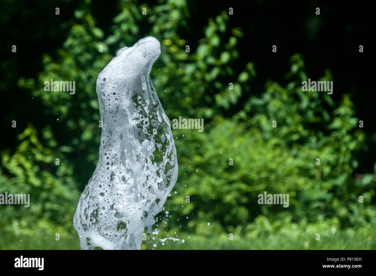 A close snapshot of gushing water with bizarre forms from a fountain in ...