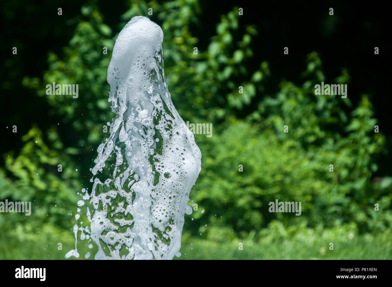 A close snapshot of gushing water with bizarre forms from a fountain in ...