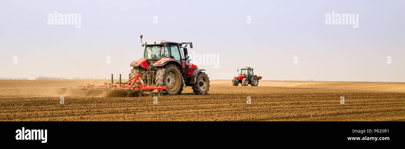 Farmer in tractor preparing land with seedbed cultivator Stock Photo ...