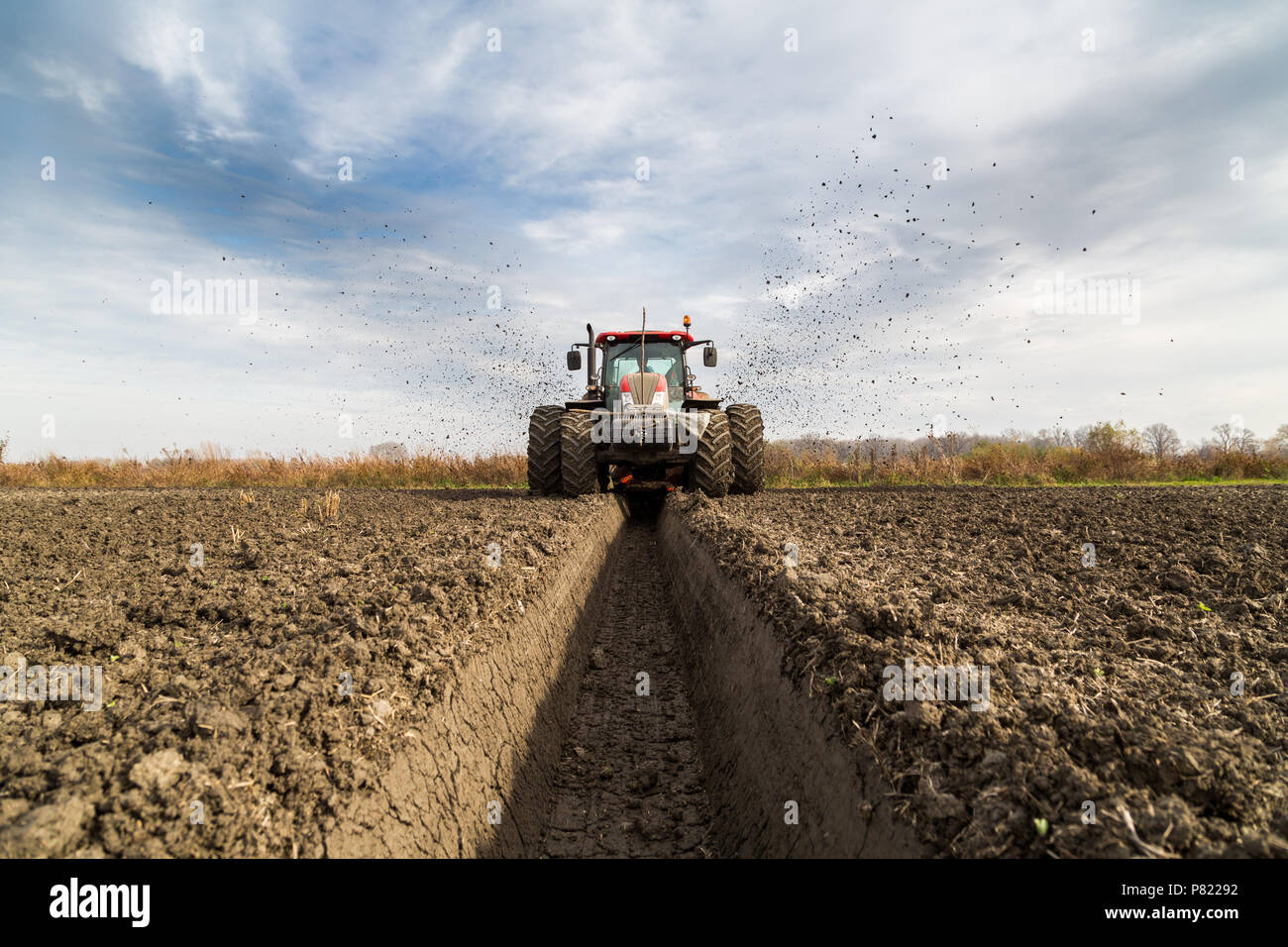 Tractor with double wheeled ditcher digging drainage canal Stock Photo ...