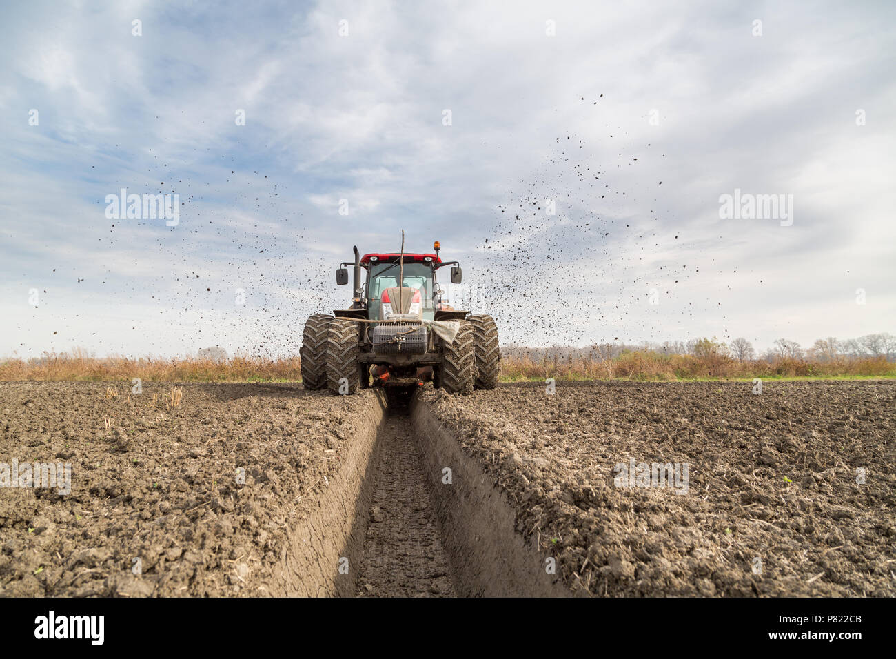 Tractor with double wheeled ditcher digging drainage canal Stock Photo - Alamy