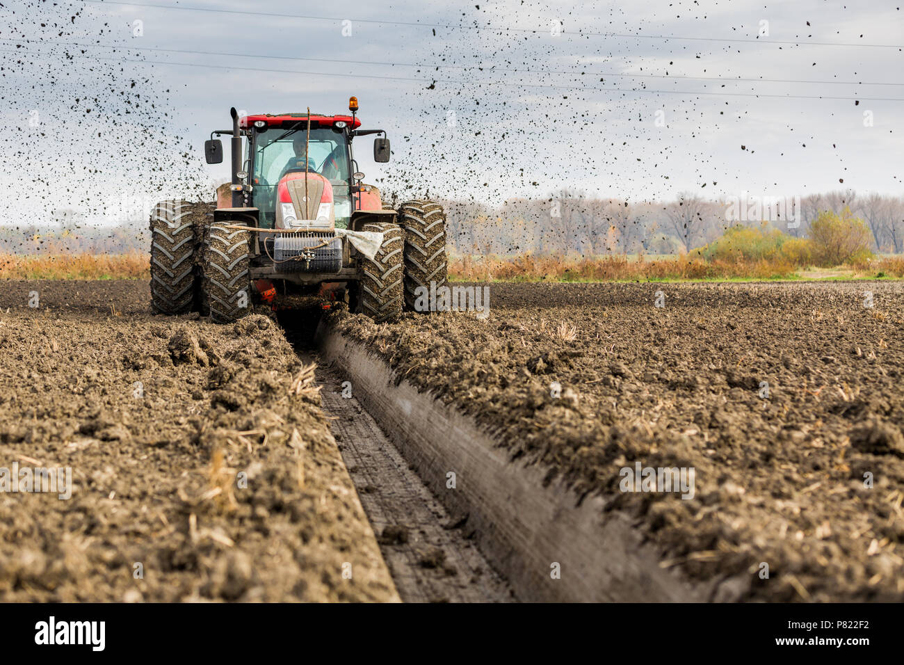 Tractor with double wheeled ditcher digging drainage canal Stock Photo ...