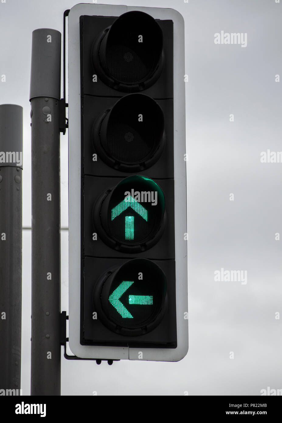 Traffic lights on green turn left or go straight ahead, UK Stock Photo ...