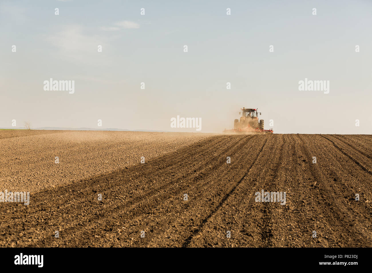 Farmer in tractor preparing land with seedbed cultivator Stock Photo ...