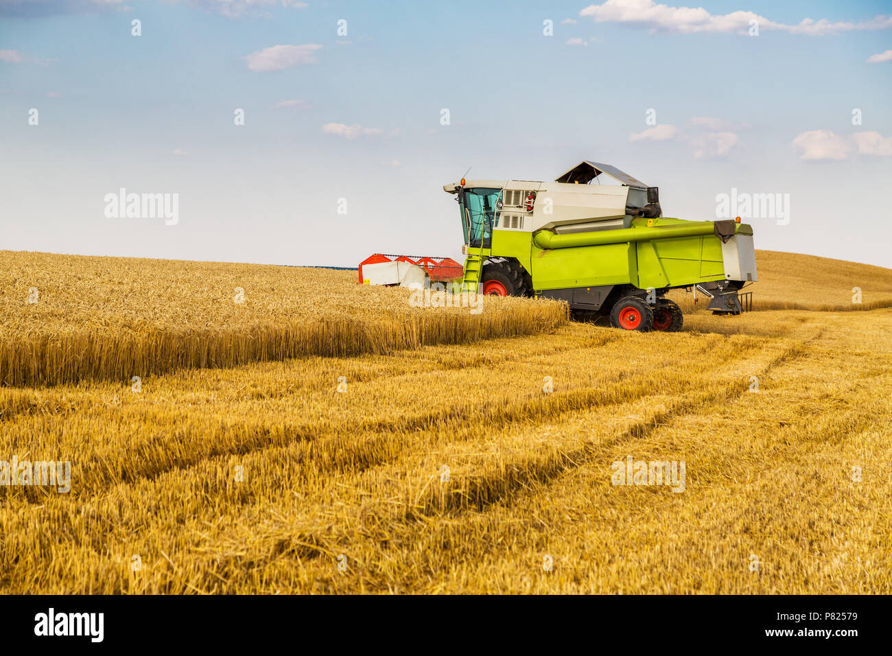 Combine harvester in action on wheat field Stock Photo - Alamy