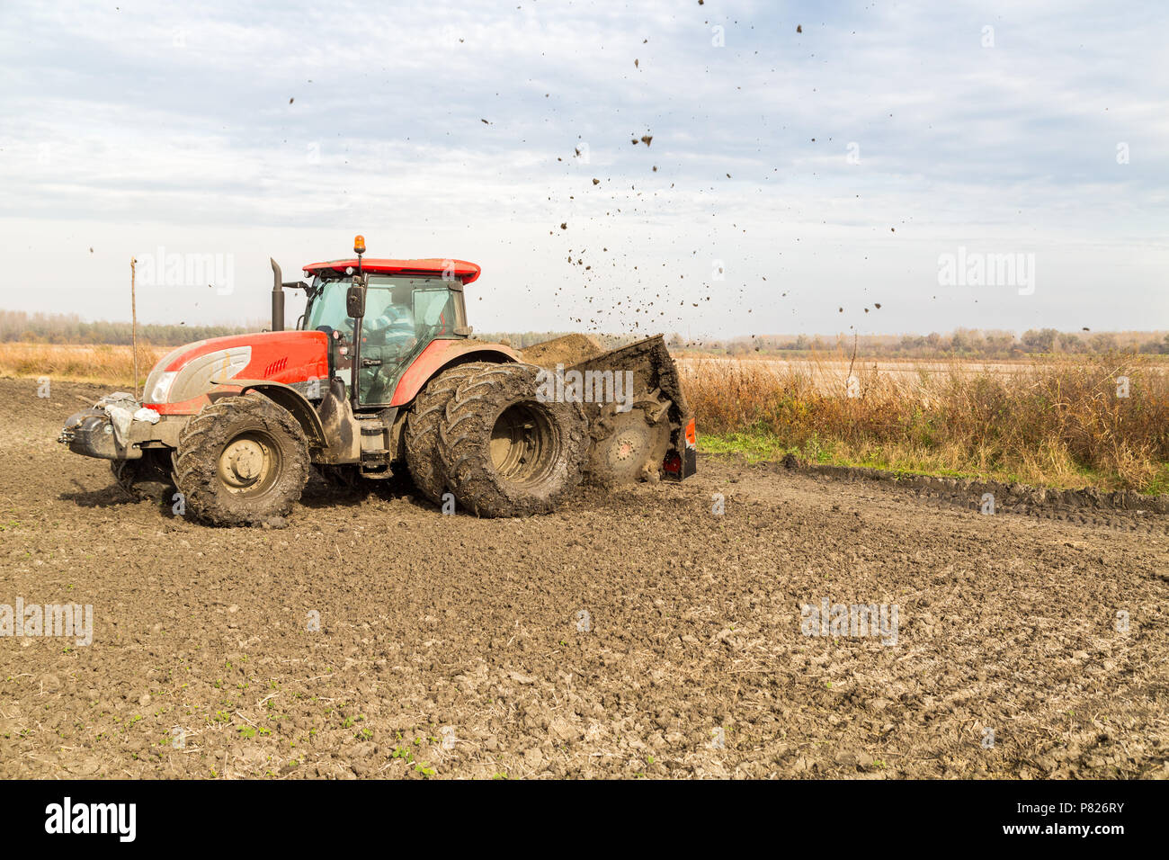 Tractor with double wheeled ditcher digging drainage canal Stock Photo - Alamy