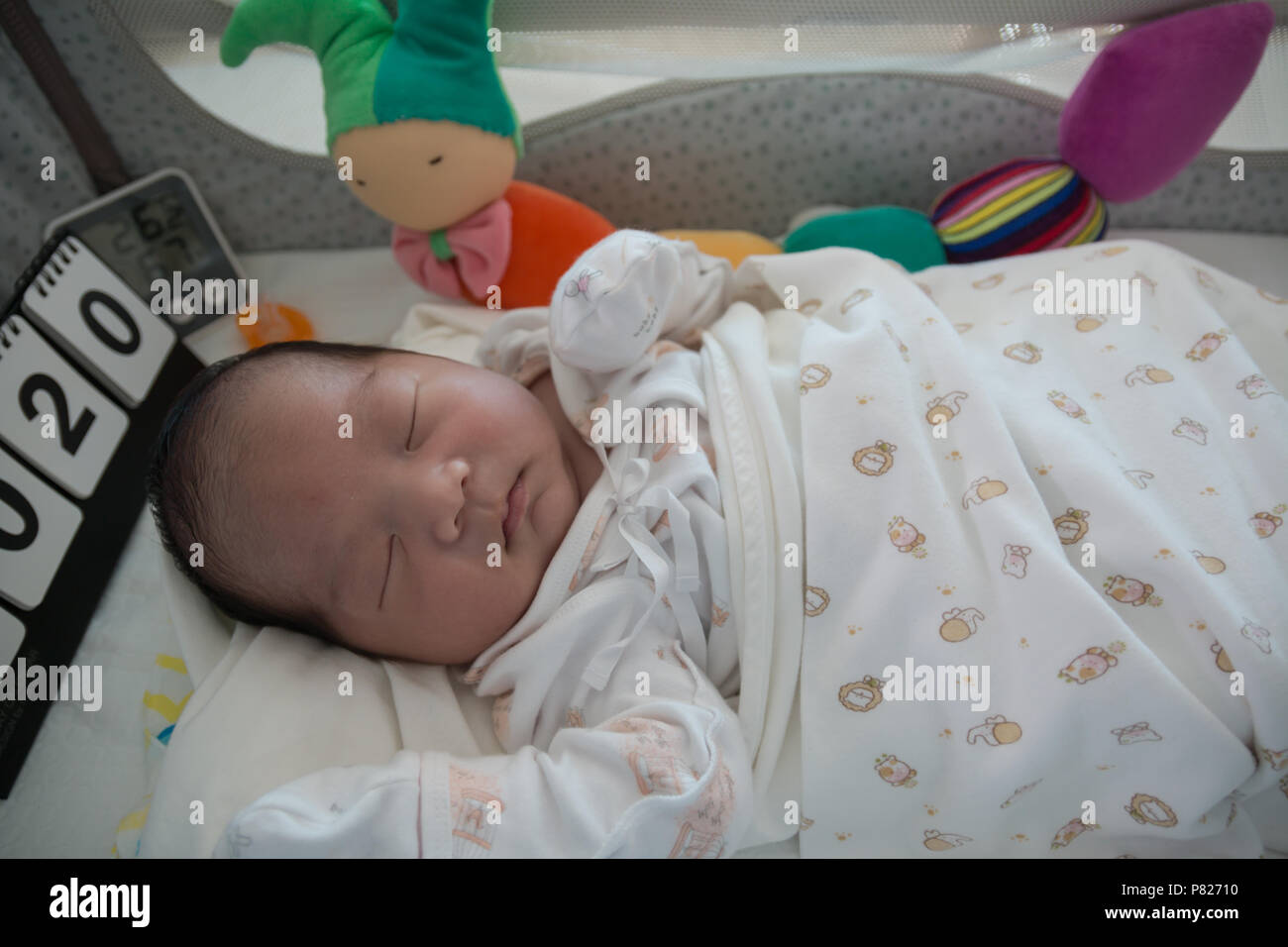 Asian baby sleeping on the bed Stock Photo - Alamy