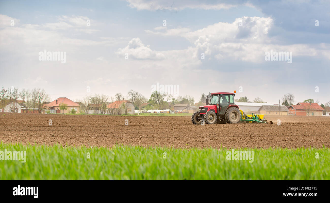 Farmer seeding, sowing crops at field Stock Photo - Alamy
