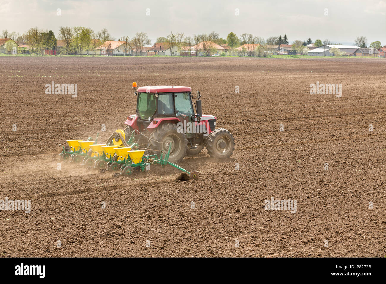 Farmer seeding, sowing crops at field Stock Photo - Alamy