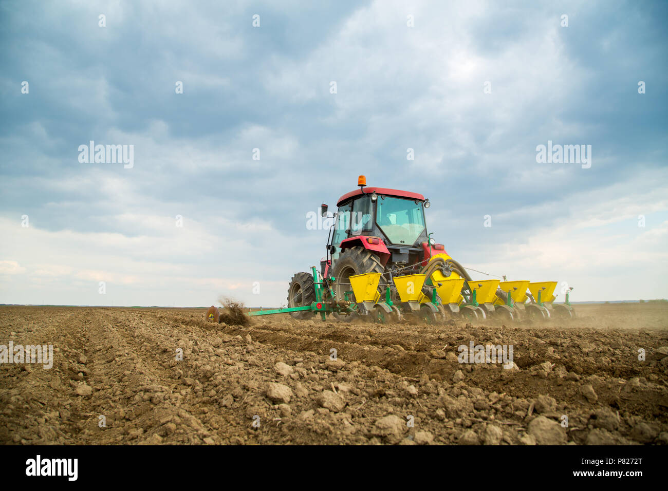 Farmer seeding, sowing crops at field Stock Photo - Alamy