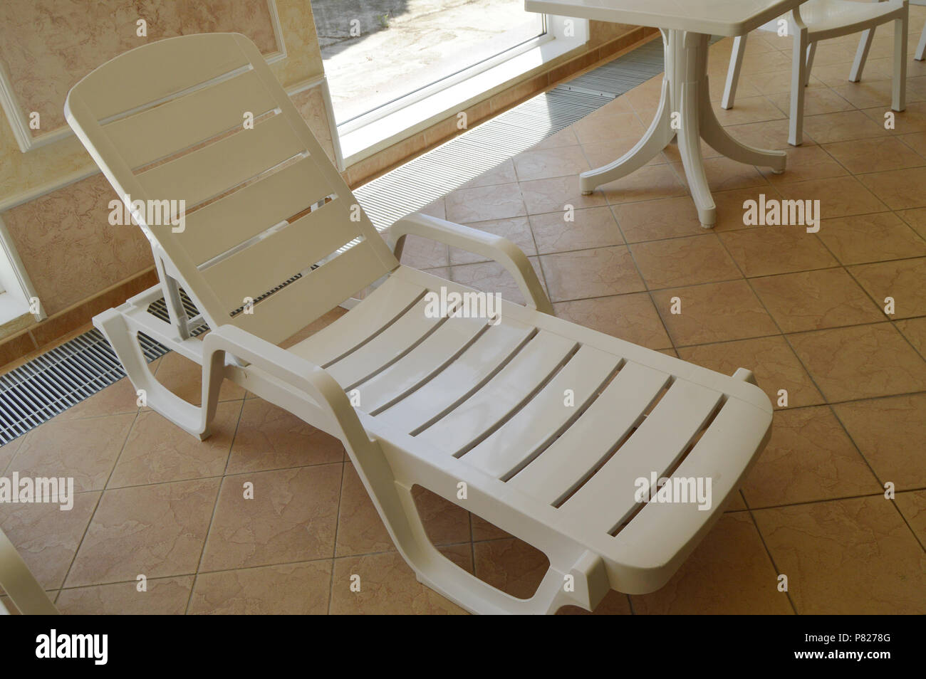 White plastic beach chair is inside the luxurious swimming pool Stock ...