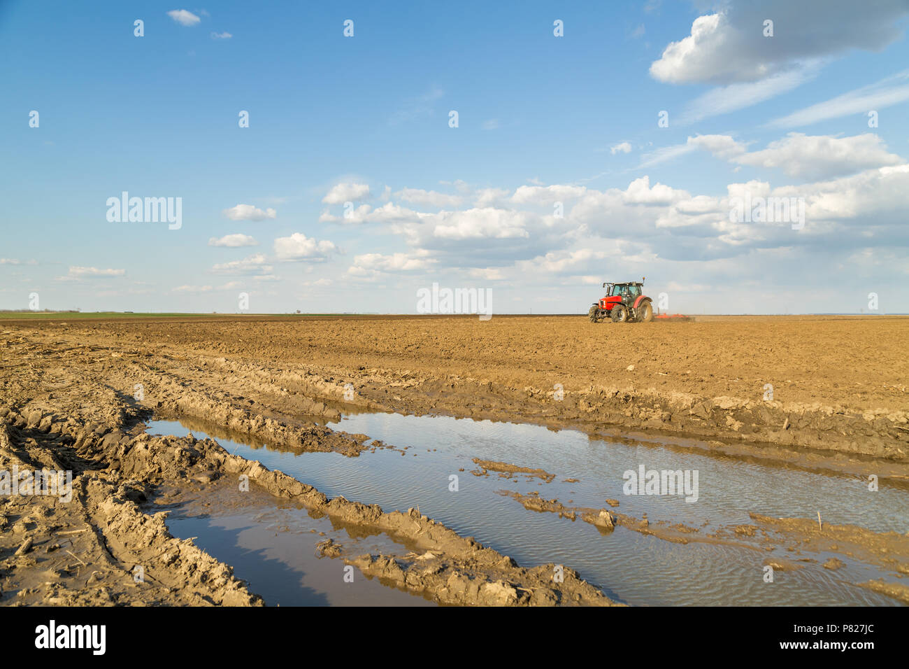 Farmer in tractor preparing land with seedbed cultivator Stock Photo ...
