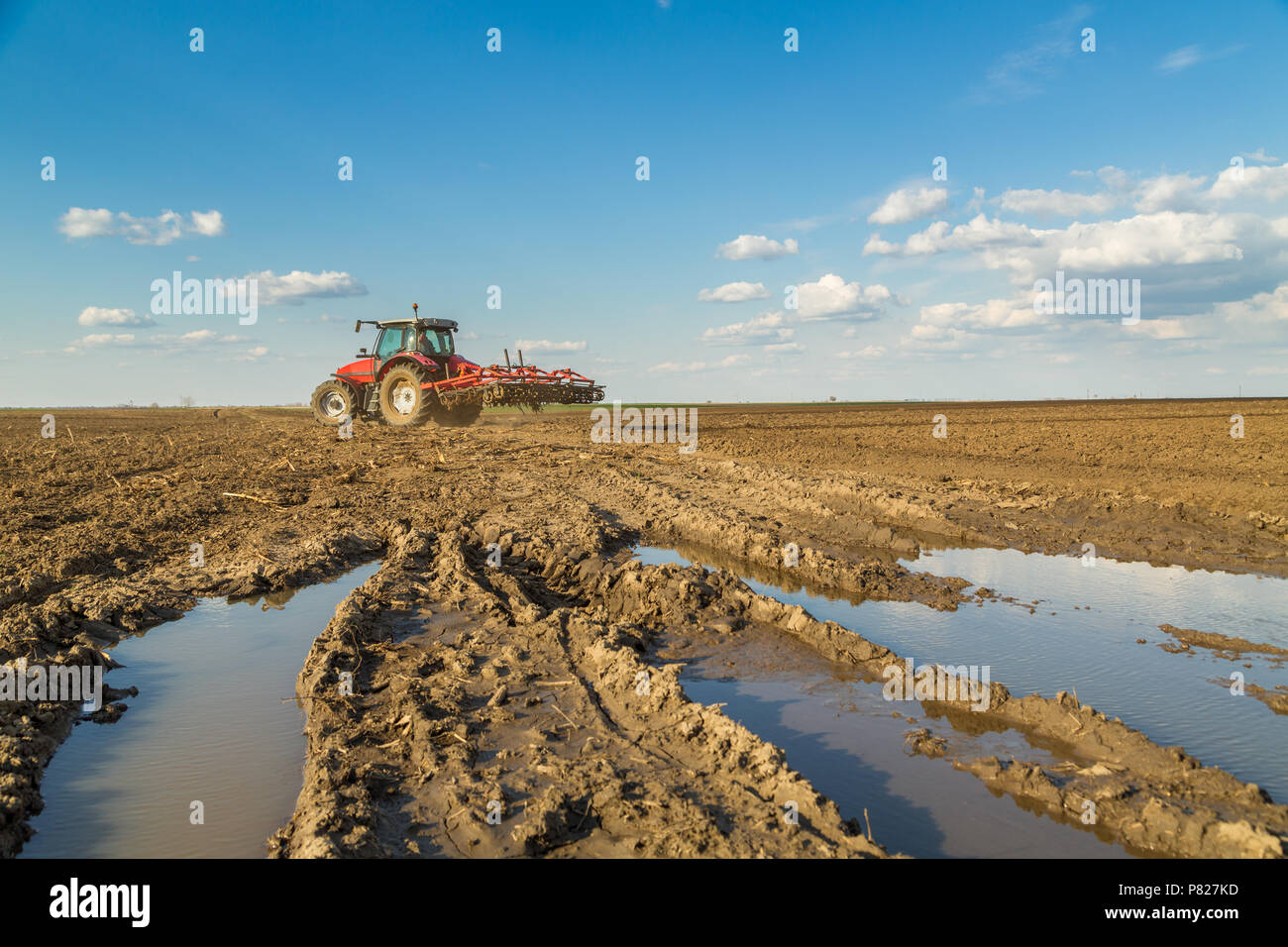 Farmer in tractor preparing land with seedbed cultivator Stock Photo ...