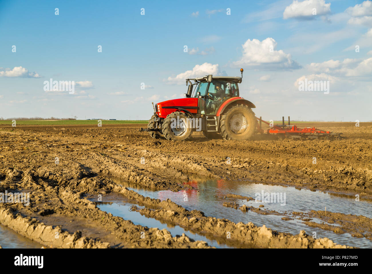 Farmer in tractor preparing land with seedbed cultivator Stock Photo ...