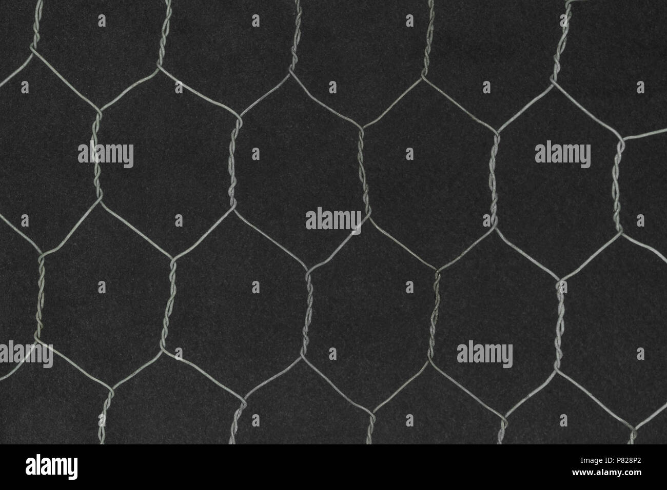 Hexagon shape metal fence on black background surface Stock Photo - Alamy