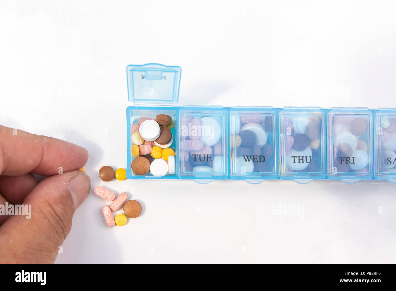 pill and drugs management daily dispenser Stock Photo - Alamy