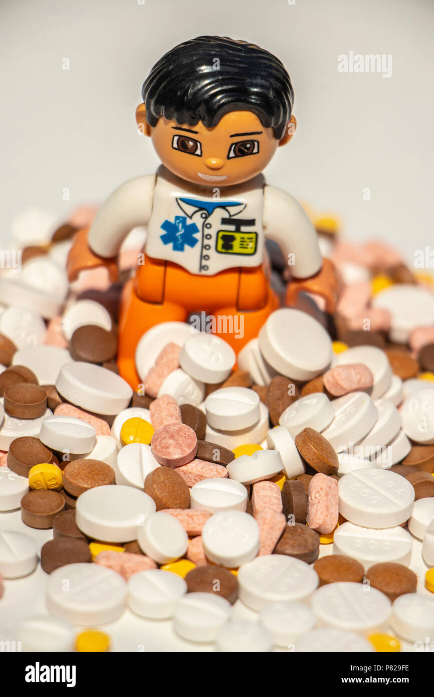 concept shot lego doctor doll surrounded by a pile of pills and drugs ...