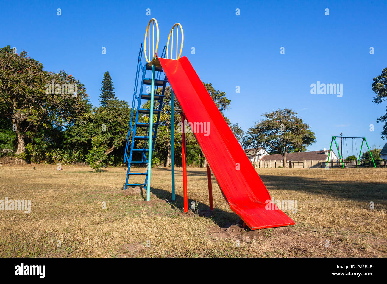 Playground closeup inside children's red painted slide chute looking ...